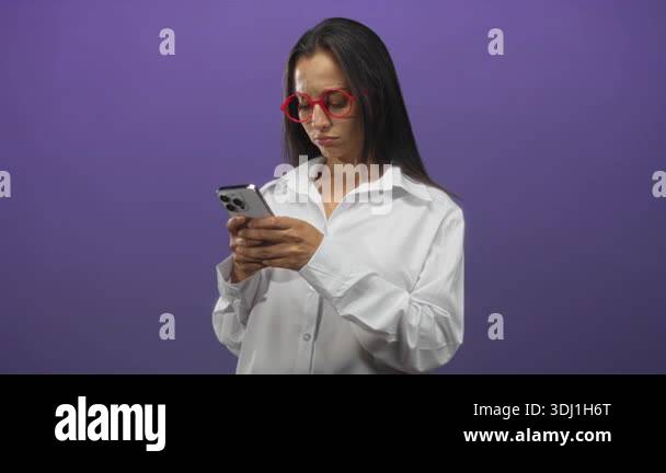 Woman wearing red glasses holding smartphone and giving thumbs up in ...