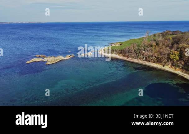 Aerial perspective reveals a beautiful coastal scene where rocky ...