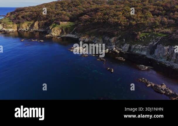 Stunning aerial view showcasing a rocky coastline with clear blue ...