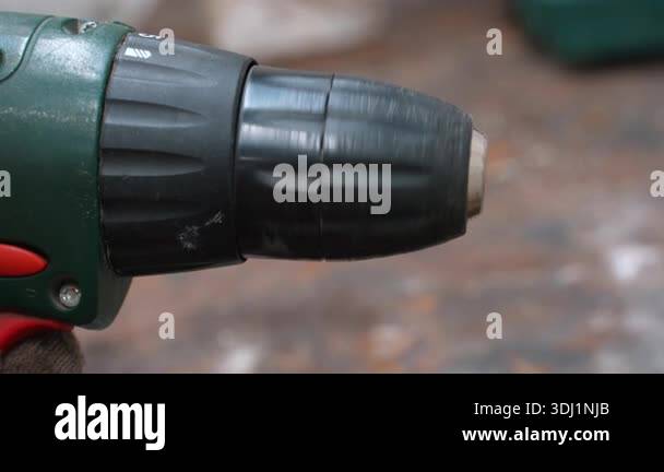 Extreme close-up of a rapidly rotating screwdriver chuck during ...