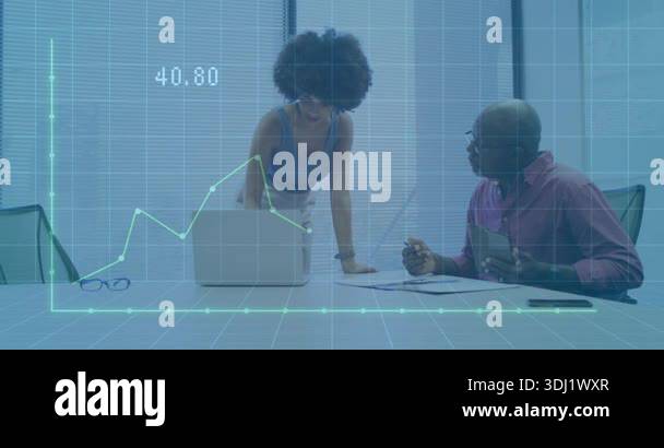 Man pointing tablet and woman leaning over laptop, analyzing rising ...