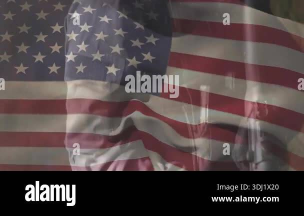 Flag overlay revealing male operator raising rifle and aligning scope ...