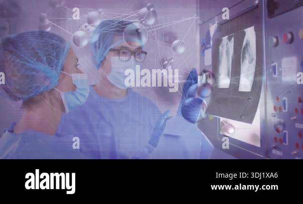 Male and female doctors approaching monitor highlighting scans with ...