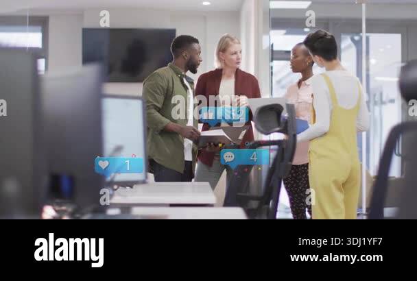 Colleagues discussing tablet content while social icons floating and ...