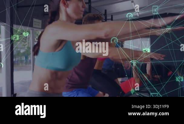 On app start, fitness group performing synchronized squats in gym with ...