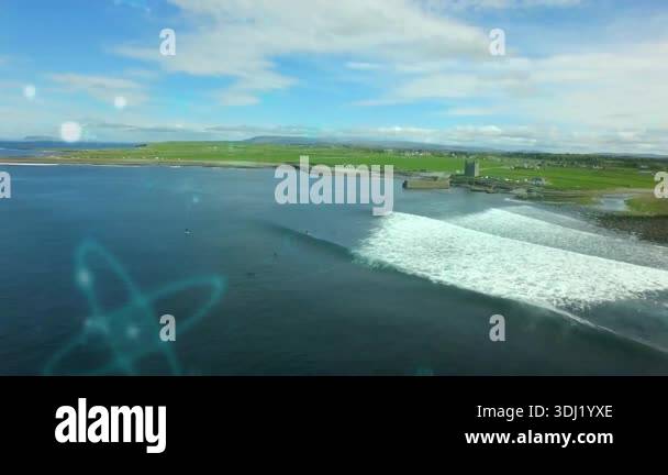 Swell building cresting foam wave by pier while teal molecules drifting ...