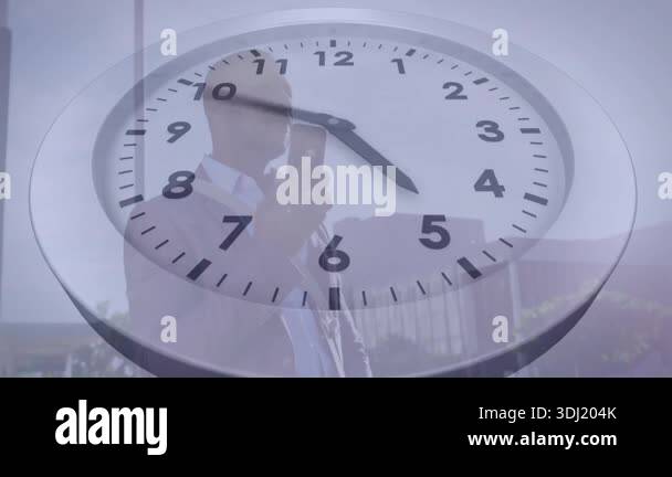 Business professional standing on terrace tracking time on smartphone ...