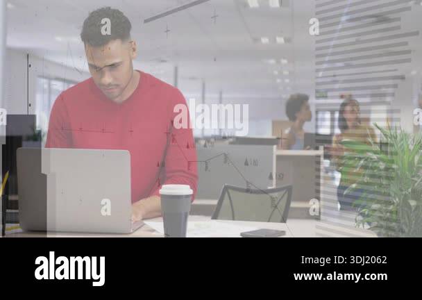 Man typing on laptop in office, causing animated graphs rising over ...