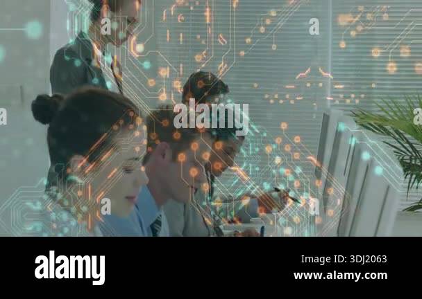 Supervisor guiding business team viewing monitors, writing notes ...