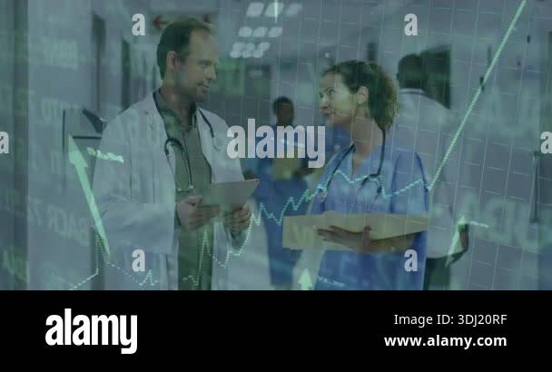 Medical team meeting at station checking status charts on tablet with ...