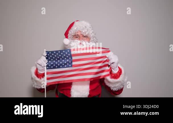 Patriotic santa claus proudly displaying the united states flag during ...