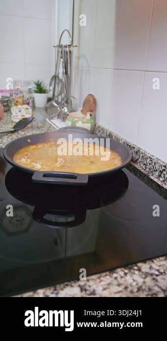 Chef cooking authentic Spanish paella on induction stove Stock Video ...