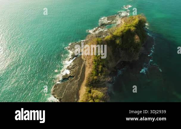 Top down view of narrow rocky peninsula and blue ocean water in Costa ...