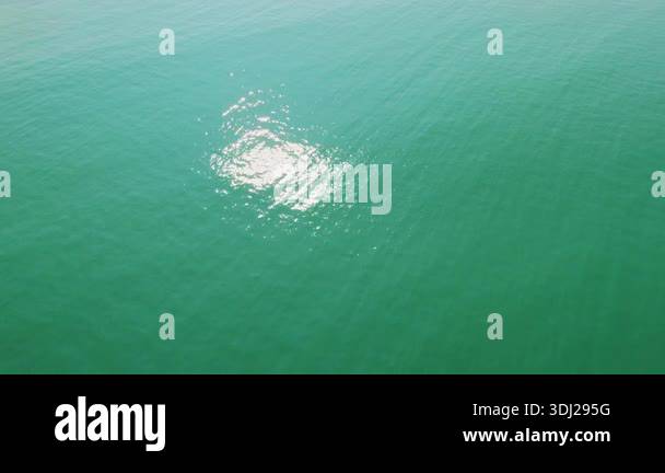 Bright sunlight reflecting on turquoise ocean water surface in Costa ...