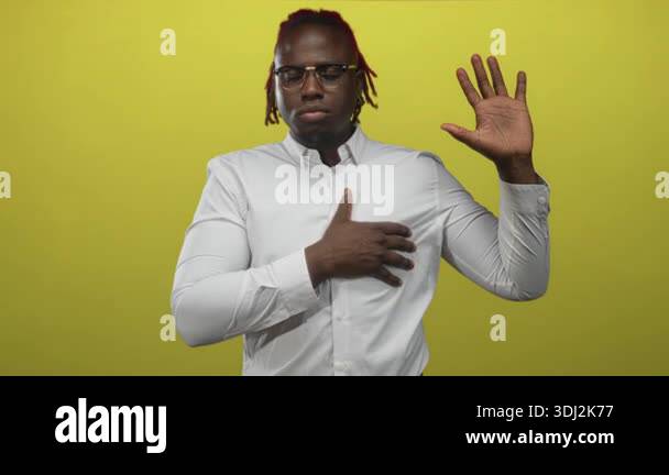 Man wearing glasses and white shirt with one hand on chest and raised ...