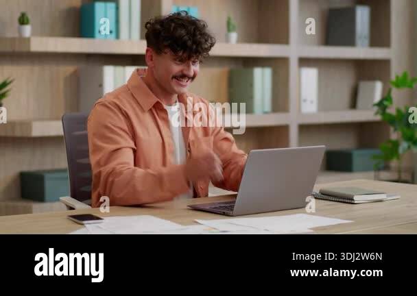 Caucasian business man winning laptop in office yelling happy ...