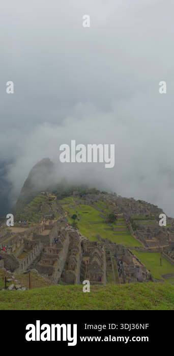A breathtaking vertical view of the Machu Picchu citadel with clouds ...