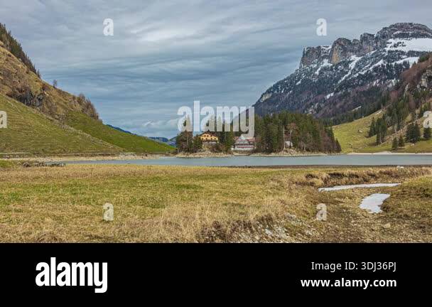 Time lapse, a scenic alpine lake surrounded by limestone cliffs and ...