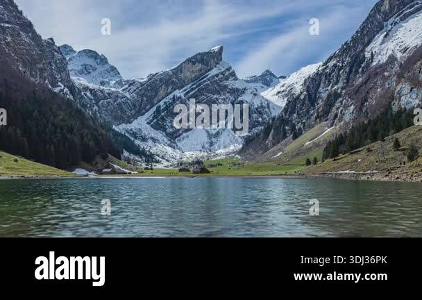 Time lapse, a scenic alpine lake surrounded by limestone cliffs and ...
