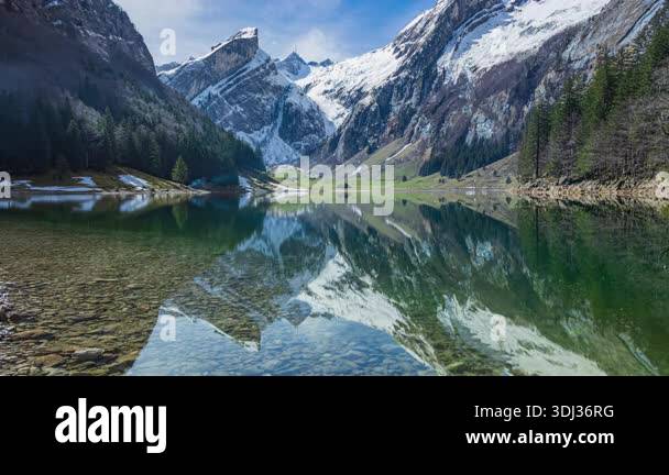 Time lapse, a scenic alpine lake surrounded by limestone cliffs and ...
