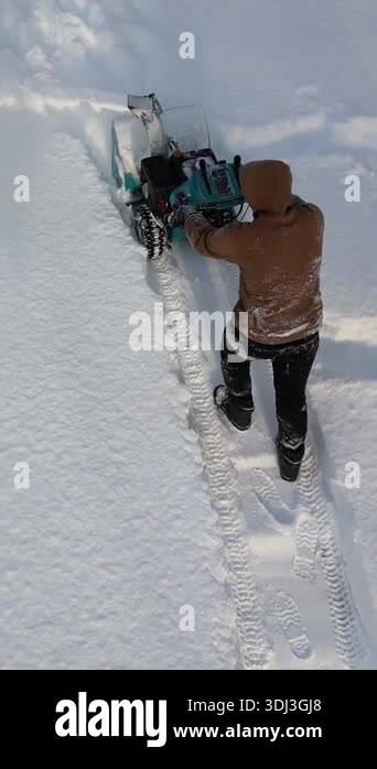 Vertical video. Man dressed in thermal winter clothing moves modern ...