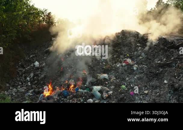 Open air garbage burning site where toxic smoke and fumes rise from ...