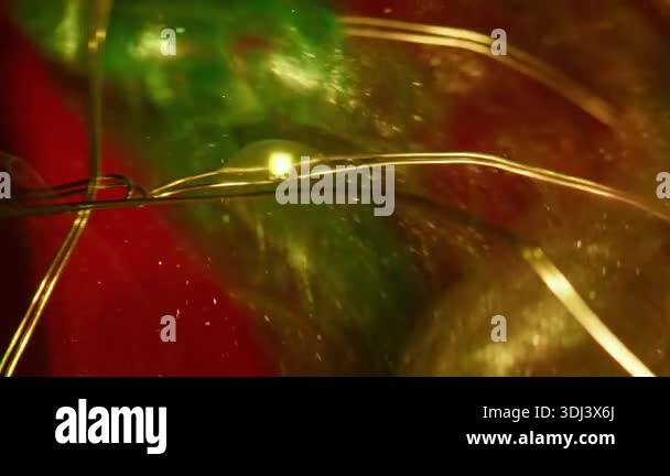 Shimmer wave. Visual light. Defocused golden green red color sparkling ...