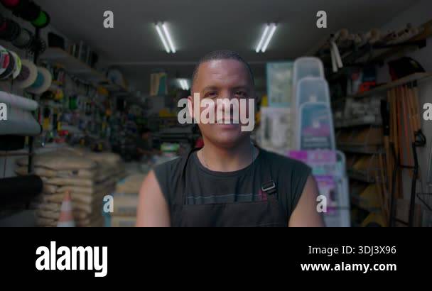 Natural portrait of Hispanic shop employee inside hardware store ...