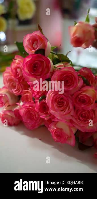 Fresh bouquet of pink roses arranged on table with soft light, romantic ...