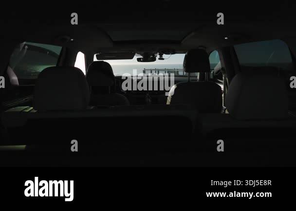 View from inside a car cabin with empty seats and windshield facing ...