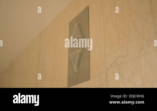 Close-up of modern triangular elevator buttons on a marble surface ...