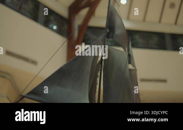 A perspective shot focusing on the multiple sails of a wooden ship ...