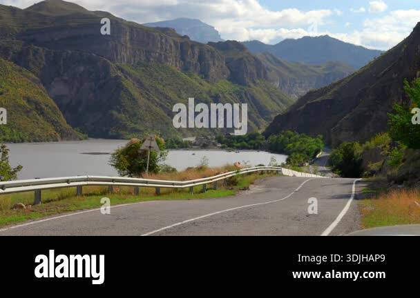 Winding Lakeside Mountain Road With Sunlit Valley View, Calm Lake ...