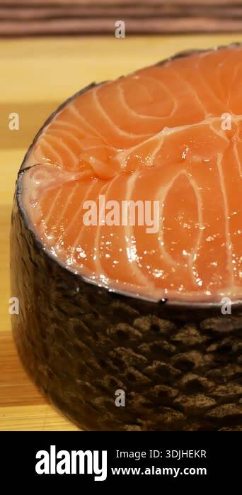 Large piece of fresh red sea fish on a wooden cutting board in the ...