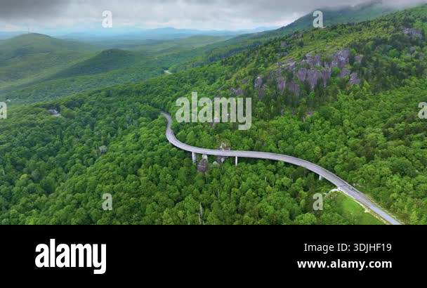 Winding mountain road in summer woods. Linn Cove Viaduct in Appalachian ...