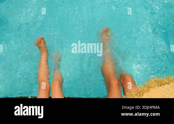 Children splashing their feet in the pool. Selective focus. Kid Stock ...