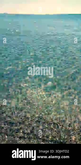 Clean transparent water on shallow sandy seashore with shells with ...