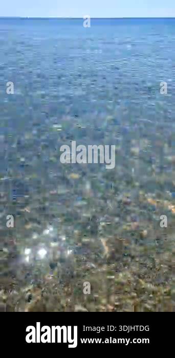Clean transparent water on shallow sandy seashore with shells with ...