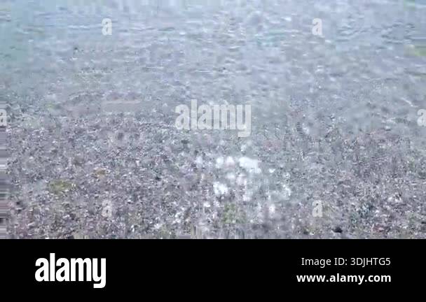 Clean transparent water on shallow sandy seashore with shells with ...
