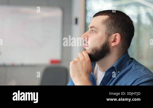 Man expresses deep contemplation, hand resting on chin, revealing ...