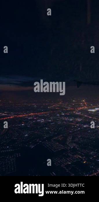 Vertical video. Overhead Style Aircraft Window View showing Vast Night ...