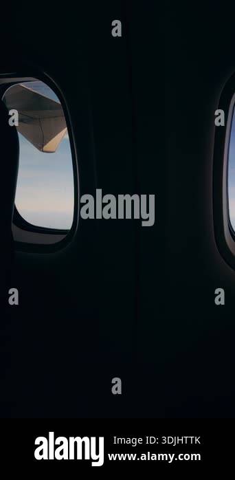 Vertical video. Silhouette of Woman Looking Out Airplane Window at Sky ...