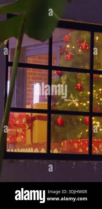 Vertical video. Christmas Tree with Red Ornaments and Lights seen ...
