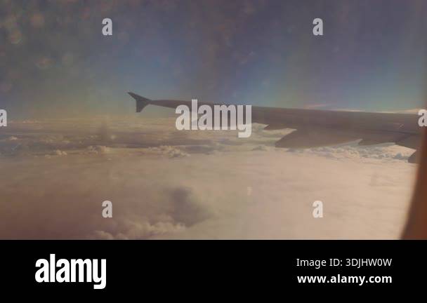 Airplane Wing above Thick Cloud Layer under Soft Sunset Glow with Wide ...