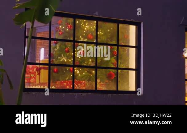 Christmas Tree with Red Ornaments and Lights seen through Window Frame ...