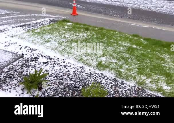 A detailed image showing a close-up view of hailstones densely covering ...