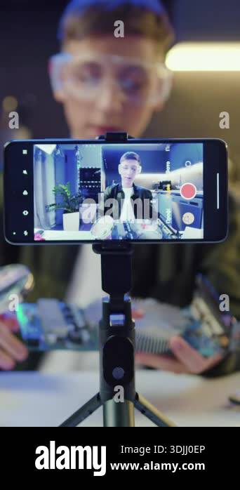 Focus on screen of smartphone. Young man is live streaming a training ...