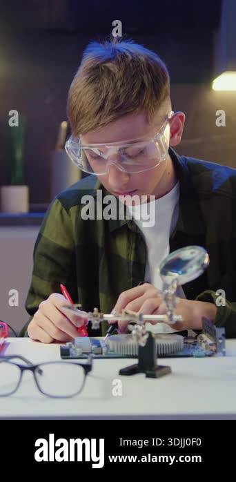Boy try to fixing computer board in school science club. Male teen ...