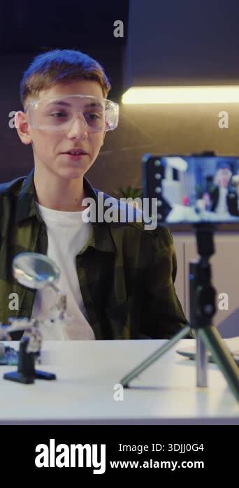 Smart teenage schoolboy vlogger makes online streaming using smartphone ...