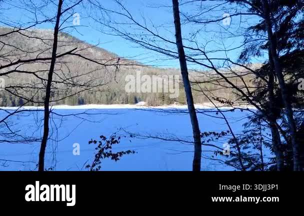 Walking past frozen winter lake in a volcano crate Stock Video Footage ...